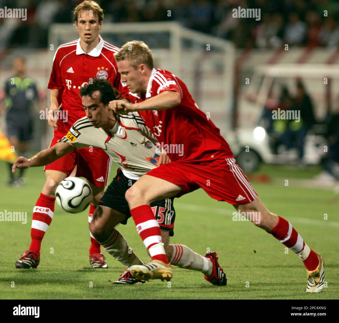 Bayern Munich's Christian Lell, right, pulls the shirt of Paulo Jorge ...