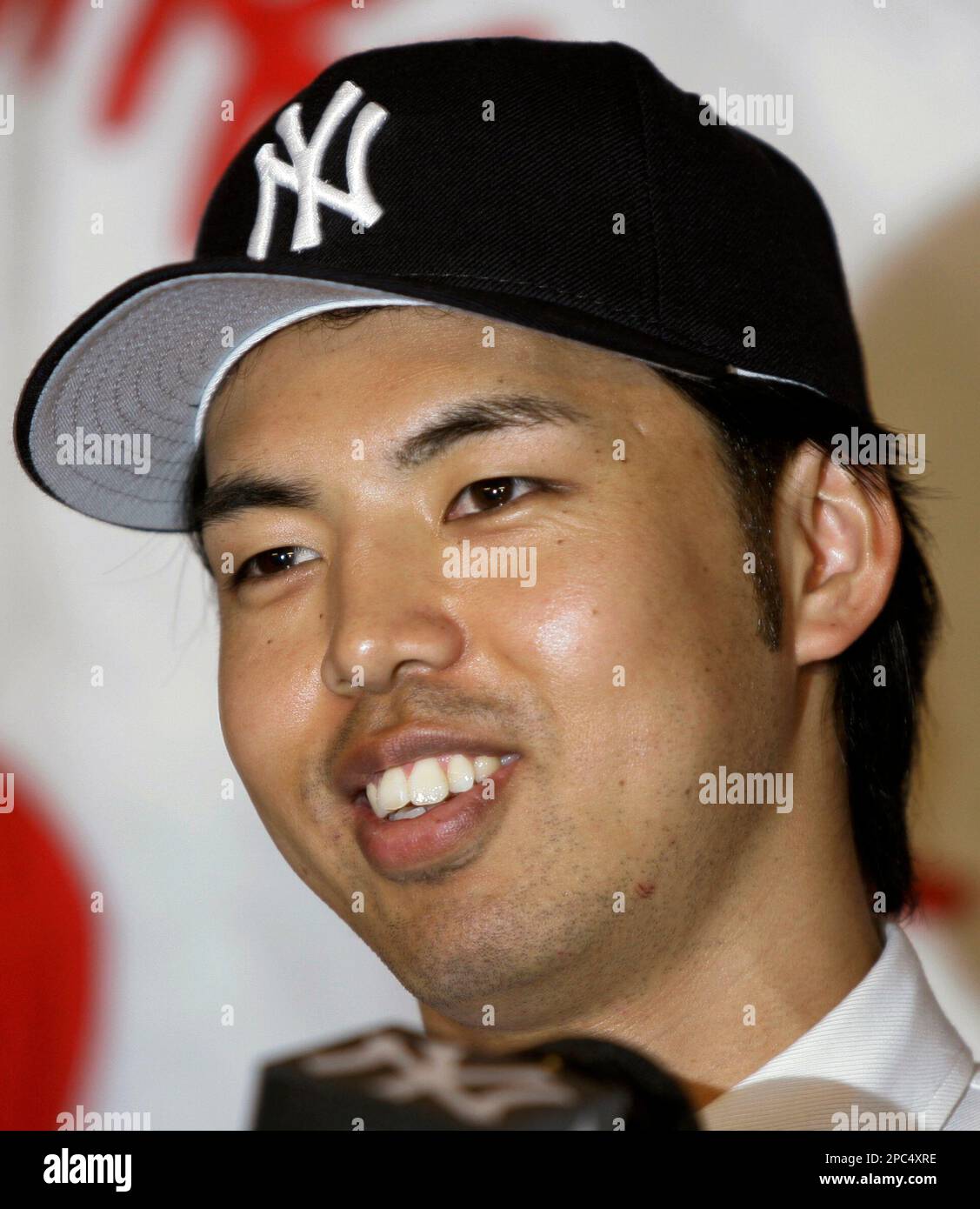 New York Yankees pitcher Kei Igawa of Japan smiles as he answers ...