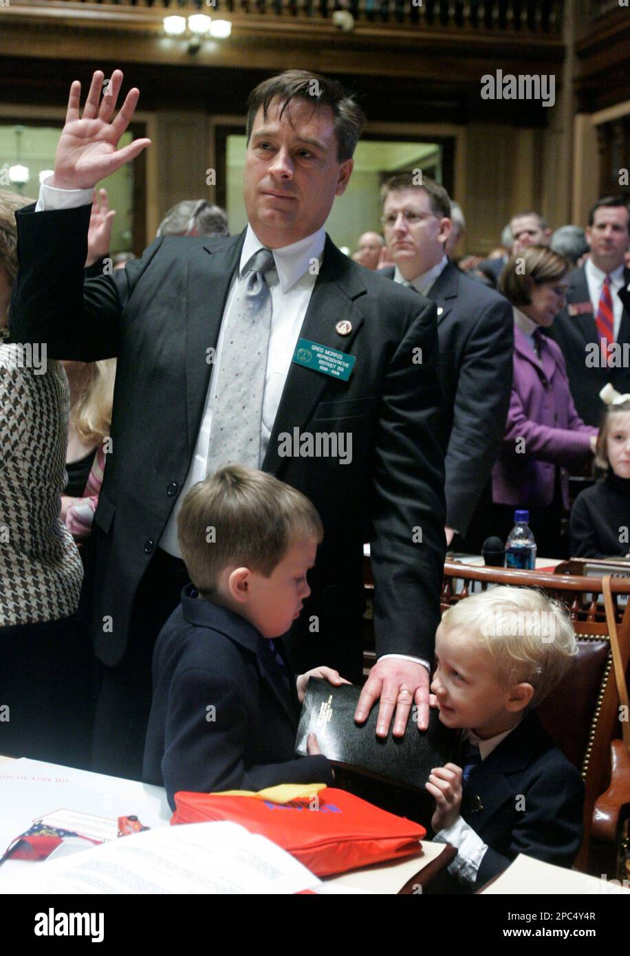 Rep. Greg Morris, D-Vidalia, is sworn in as his sons Andrew, left, and ...