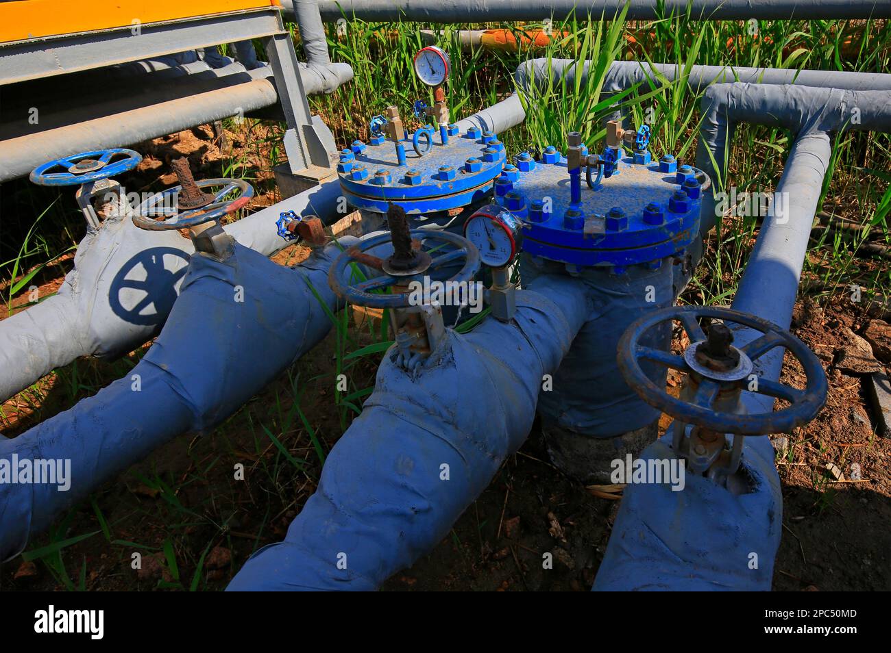 Oil pipes and valves Stock Photo - Alamy
