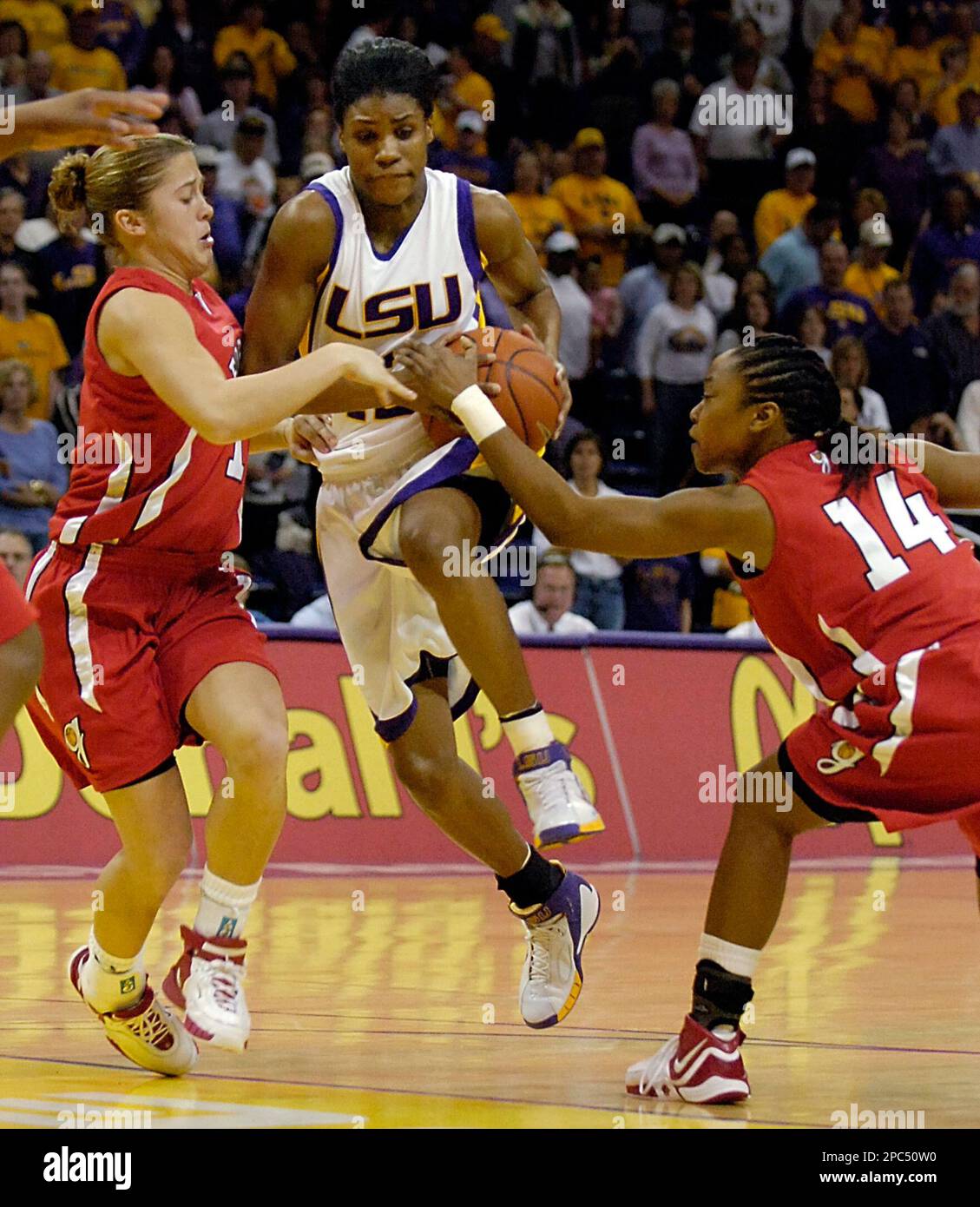 Louisiana State's RaShonta LeBlanc, center, attempts to squeeze between ...