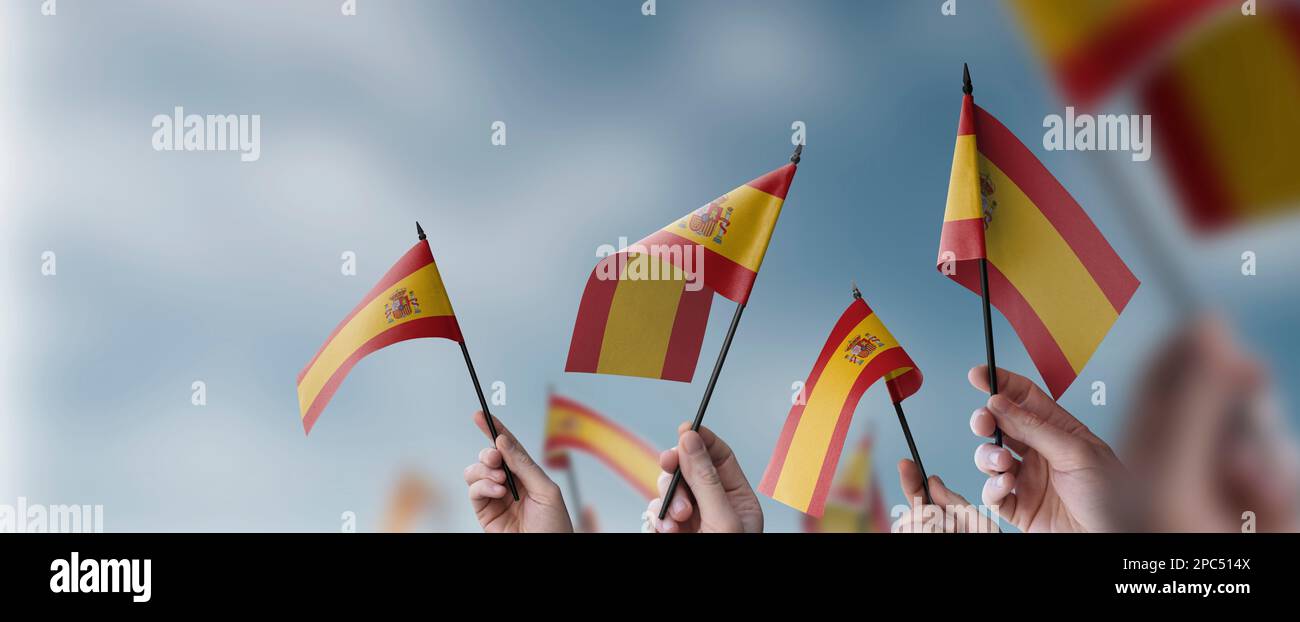 A group of people holding small flags of the Spain in their hands Stock ...