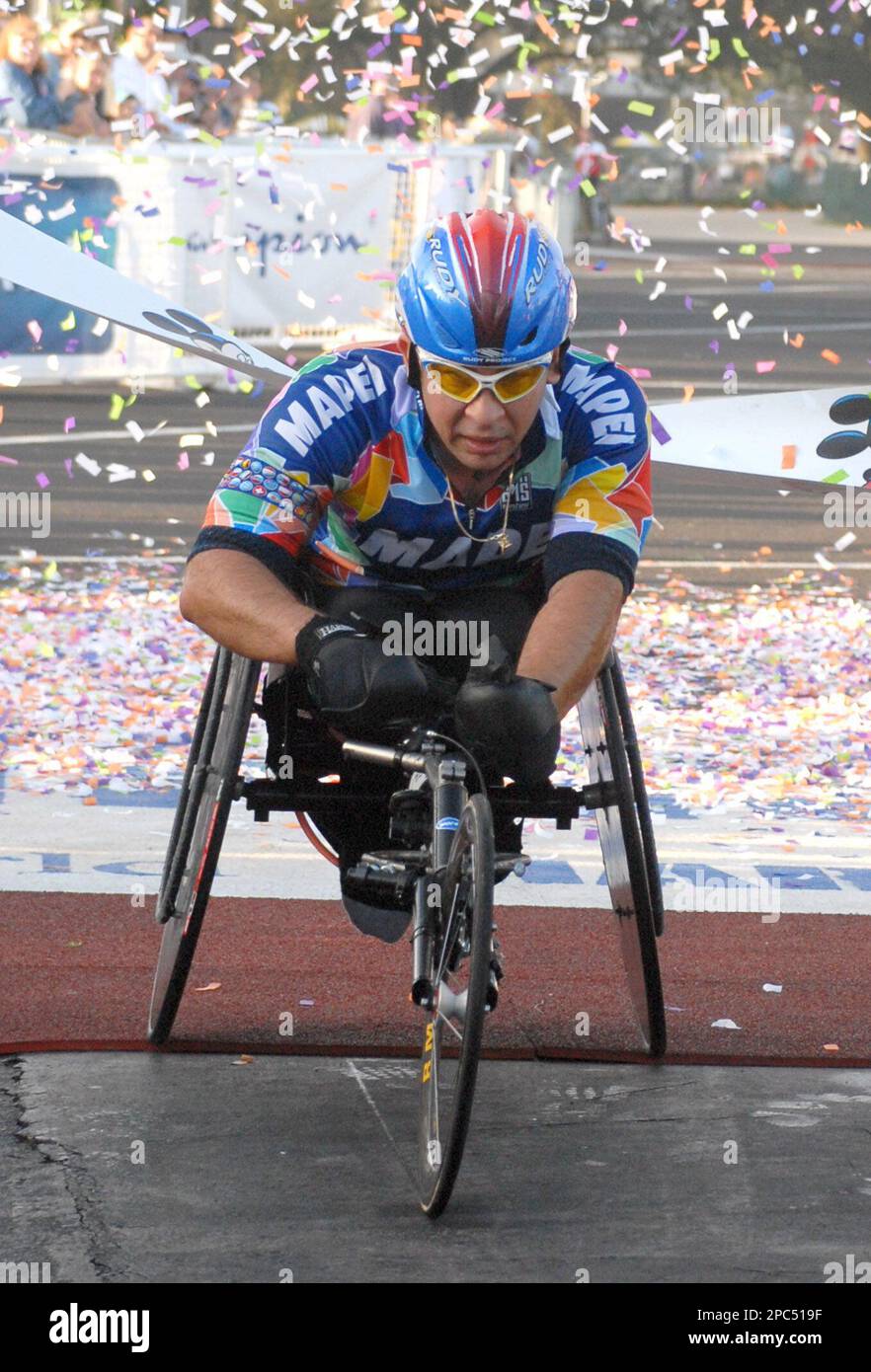 Renzo Martinez, of Boca Raton, Fla., crosses the finish line to win the ...