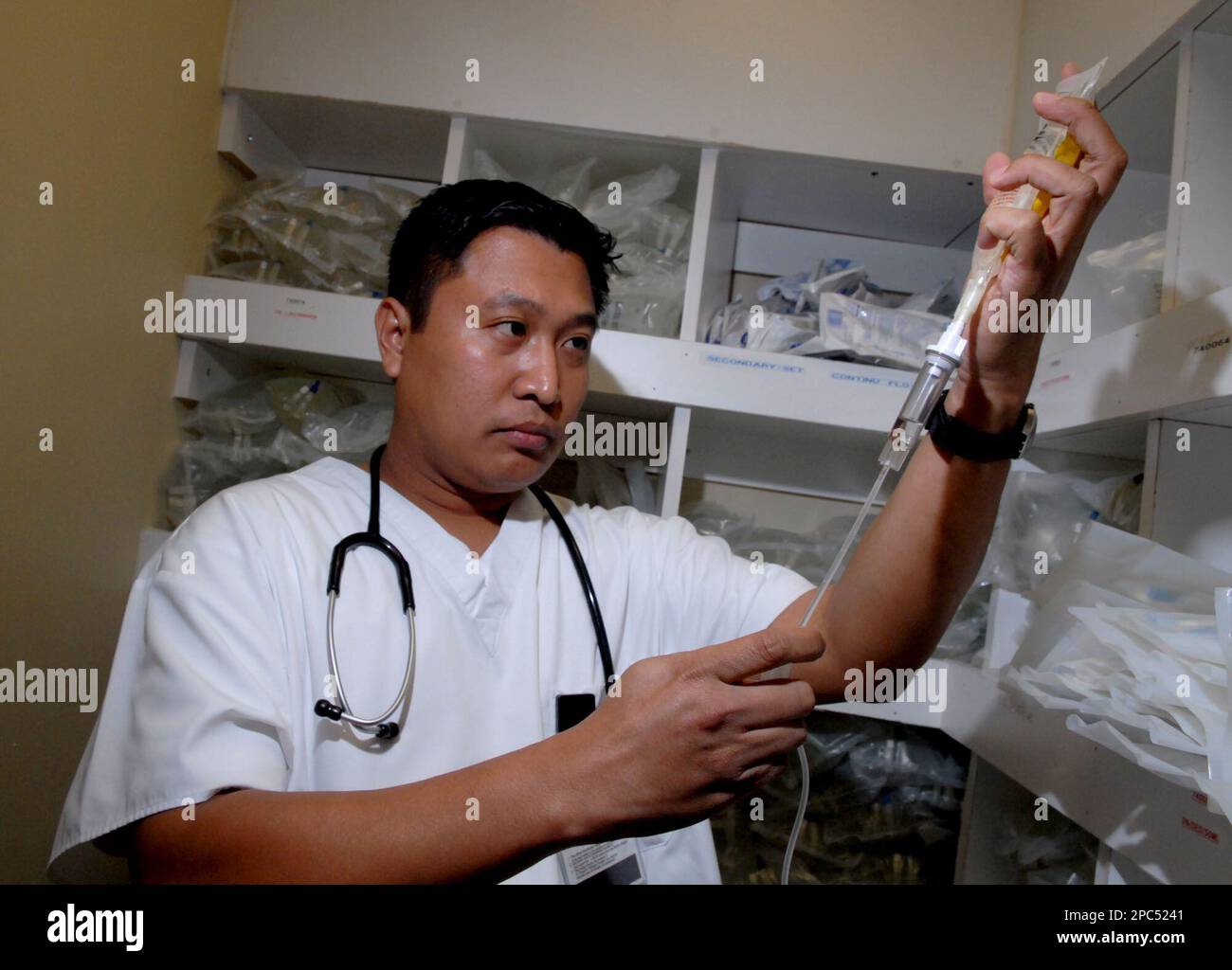Filipino nurse Elmer Jacinto prepares medicine as he does his rounds at St. Vincent's Midtown ...