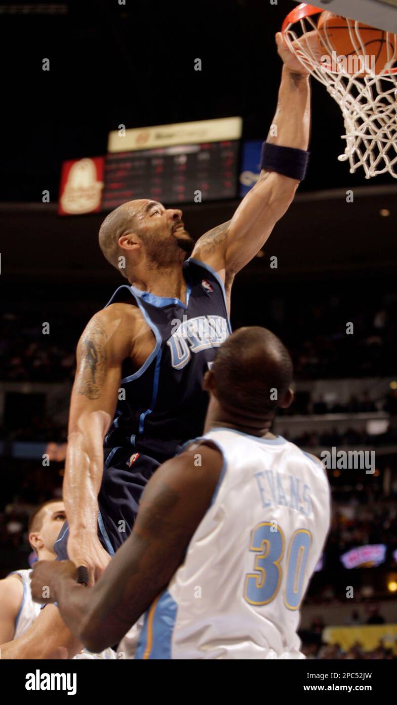 Utah Jazz center Carlos Boozer, back, goes up for a basket over Denver ...