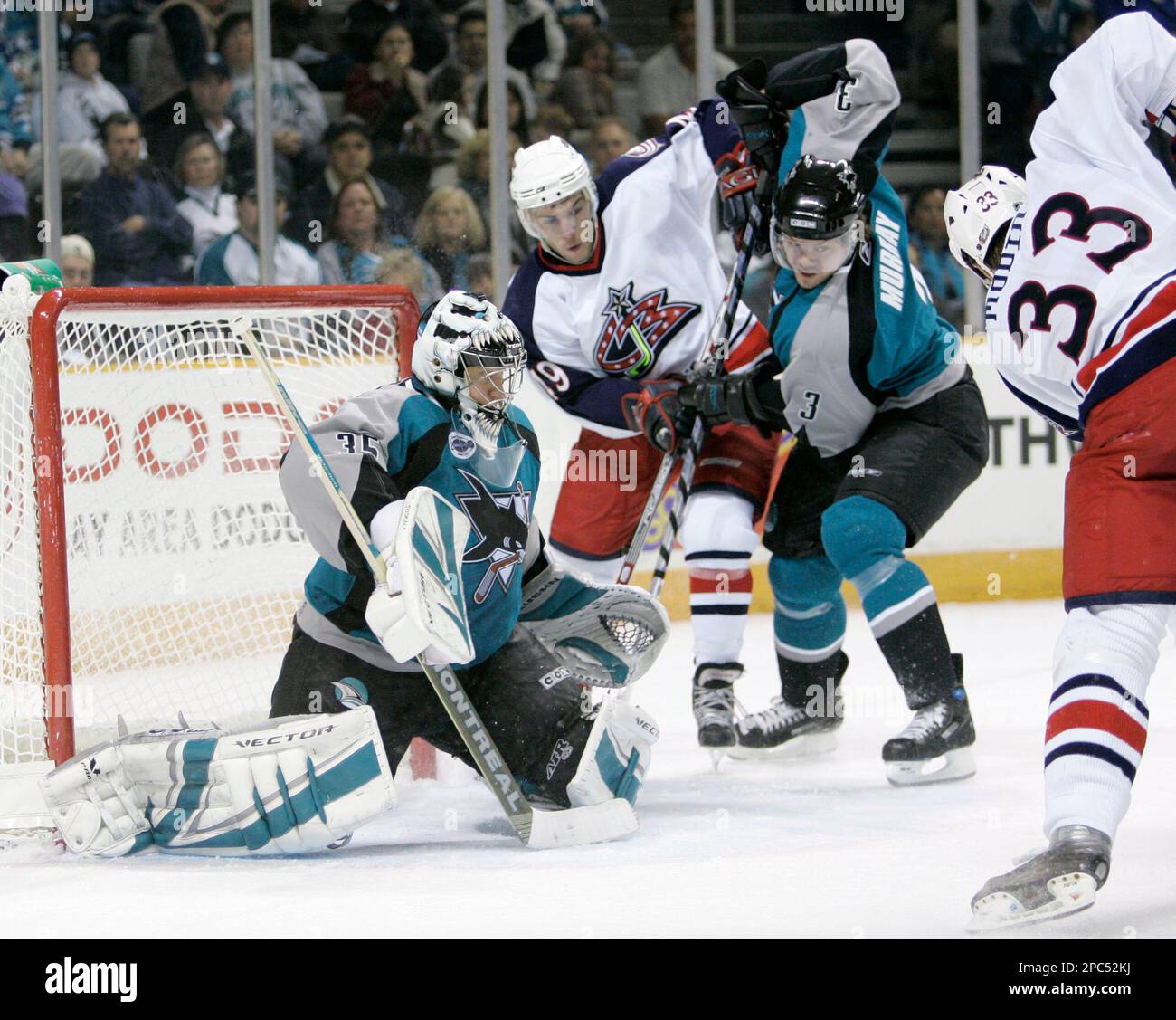 San Jose Sharks goalie Vesa Toskala, left, of Finland, waits for a shot ...