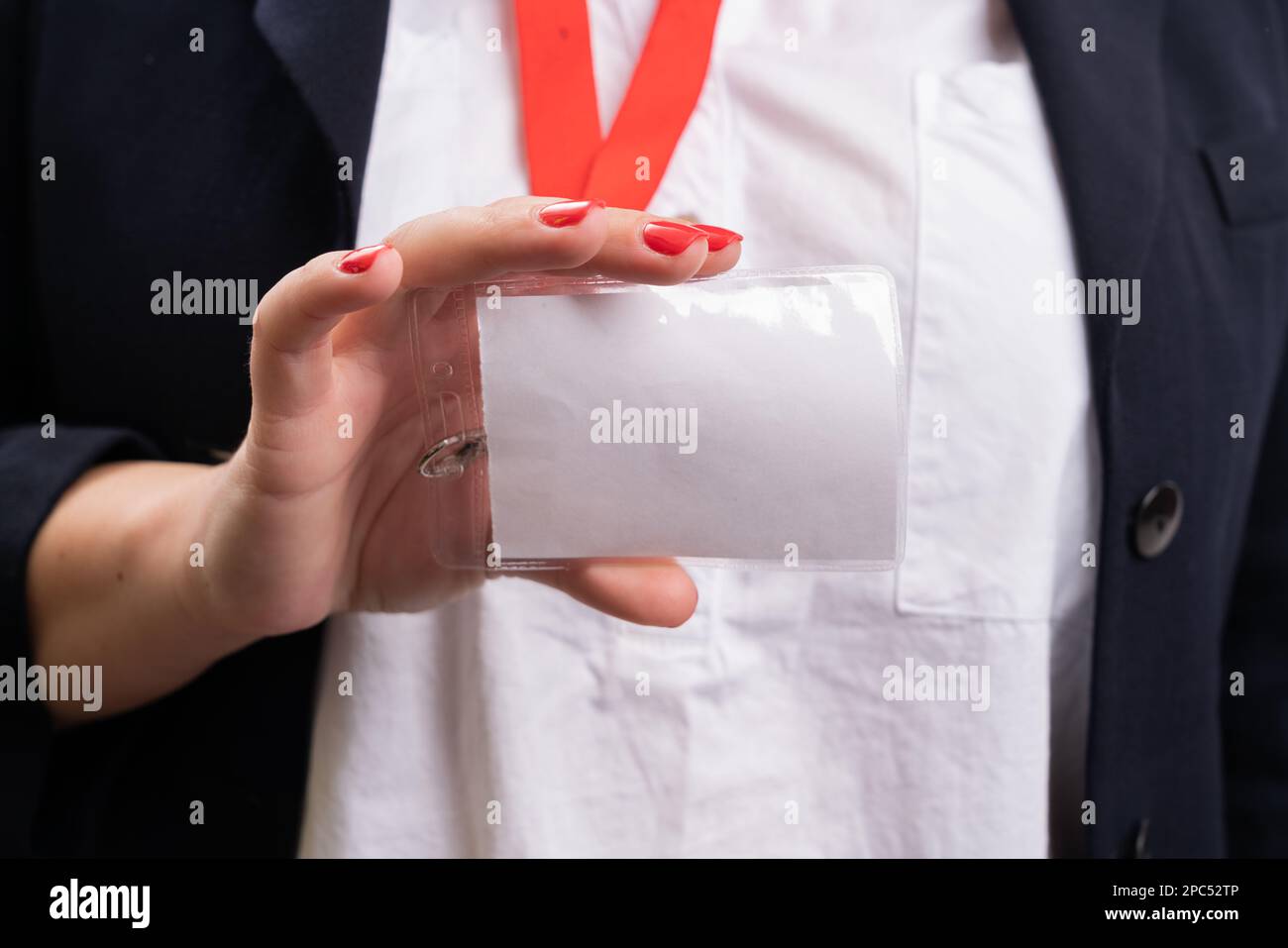 Close-up of businesswoman in formalwear holding presenting empty name ...