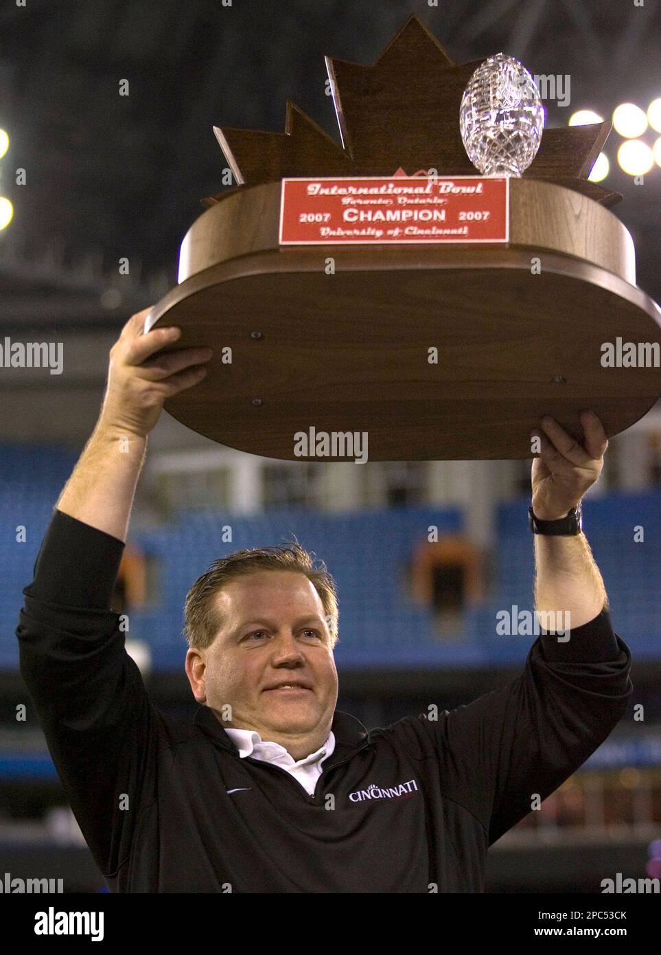 Cincinnati head coach Brian Kelly hoists the inaugural NCAA ...