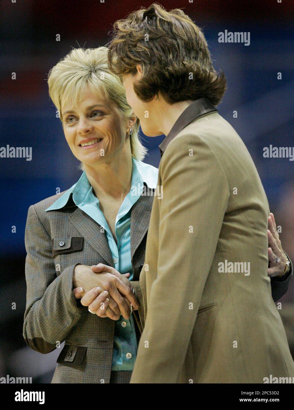 Baylor coach Kim Mulkey, left, shakes hands with Kansas coach Bonnie ...