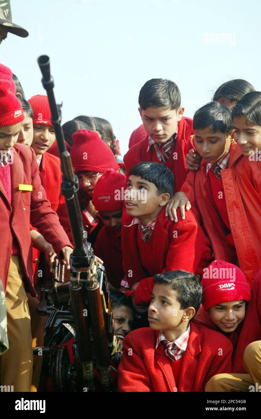 Indian schoolchildren learn about a gun, during a "Know your army ...