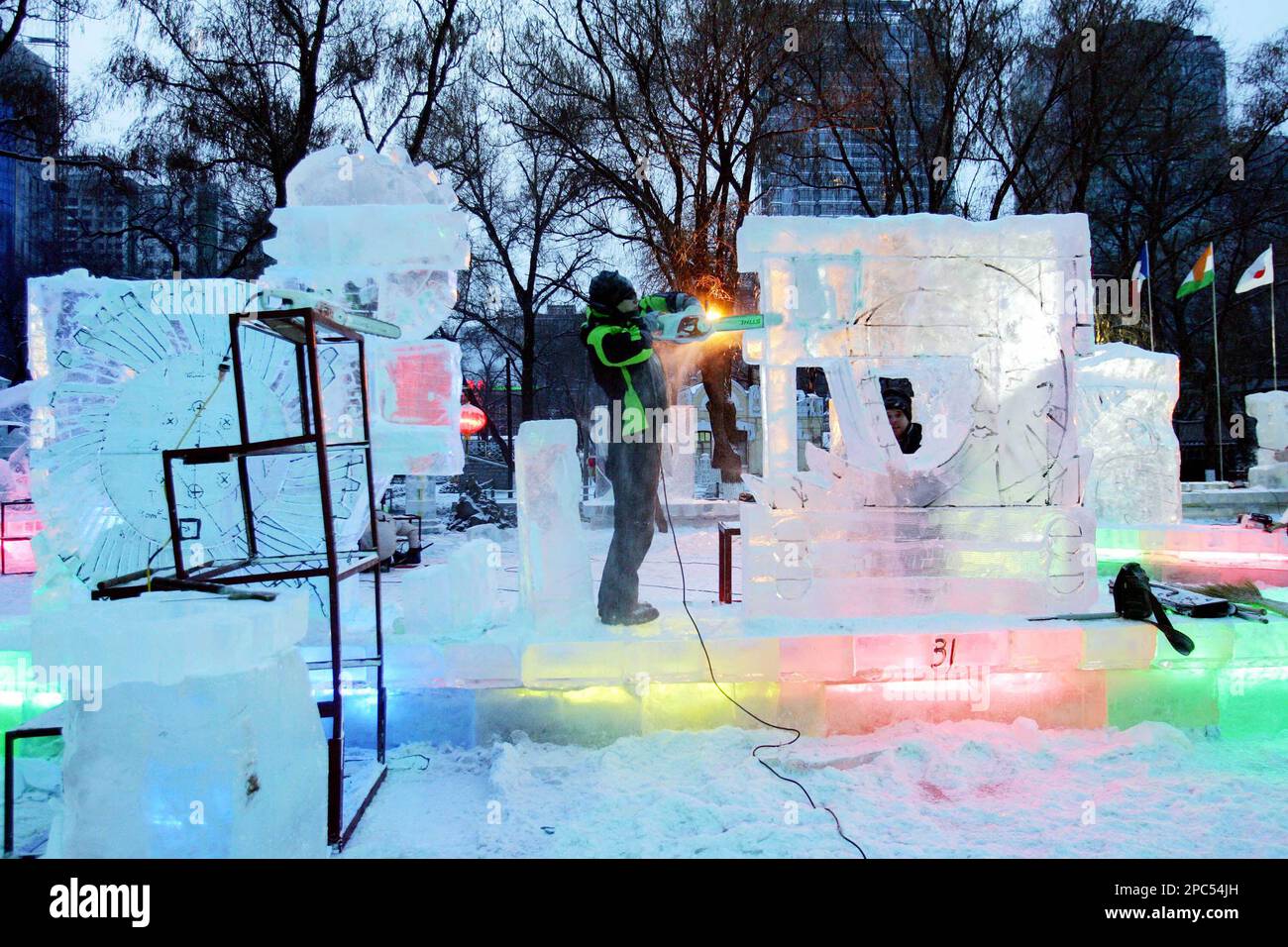 A Russian contestant in an ice carving competition works on his ...