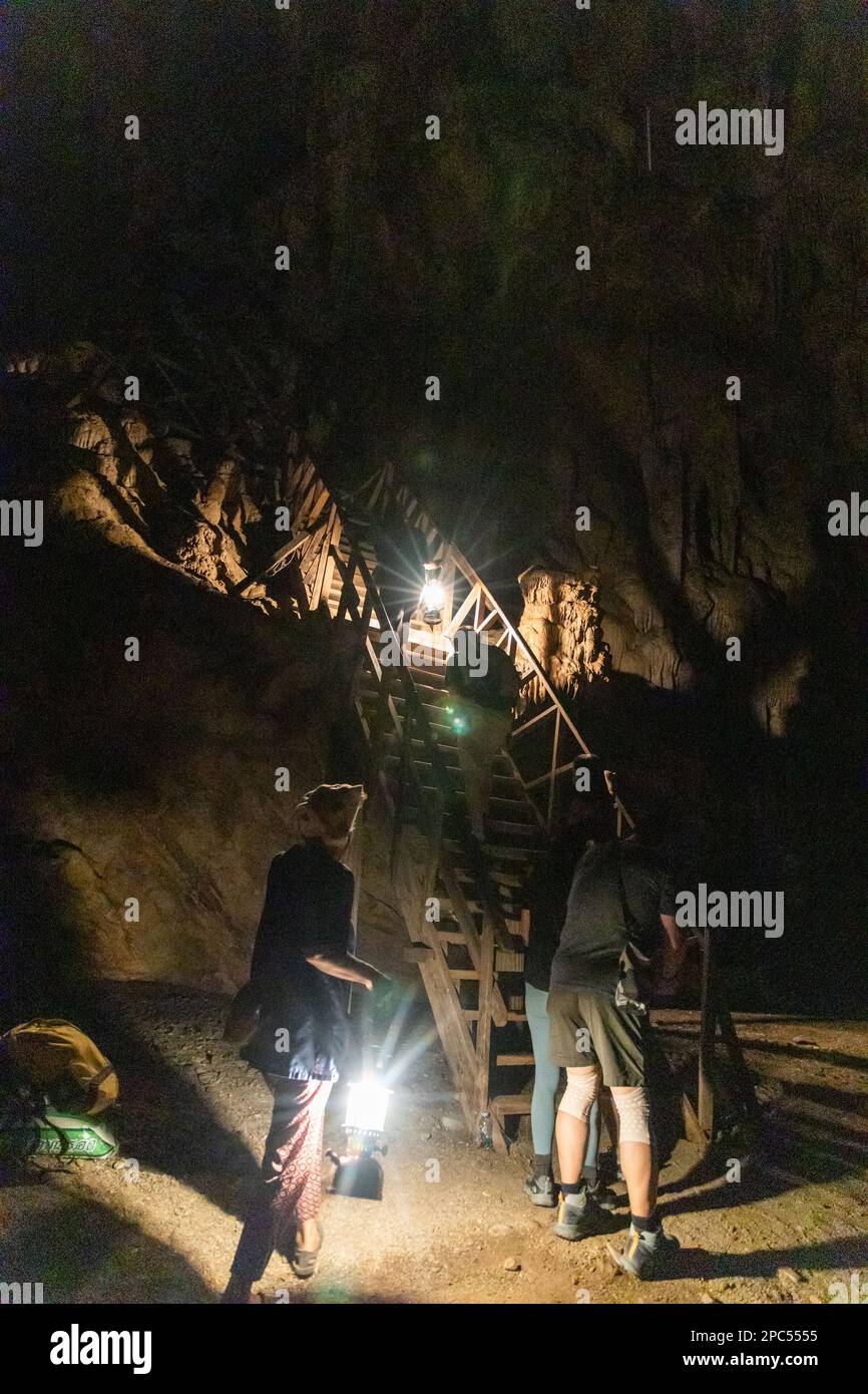 Local tour guide with traditional lantern guiding tourists through the ...