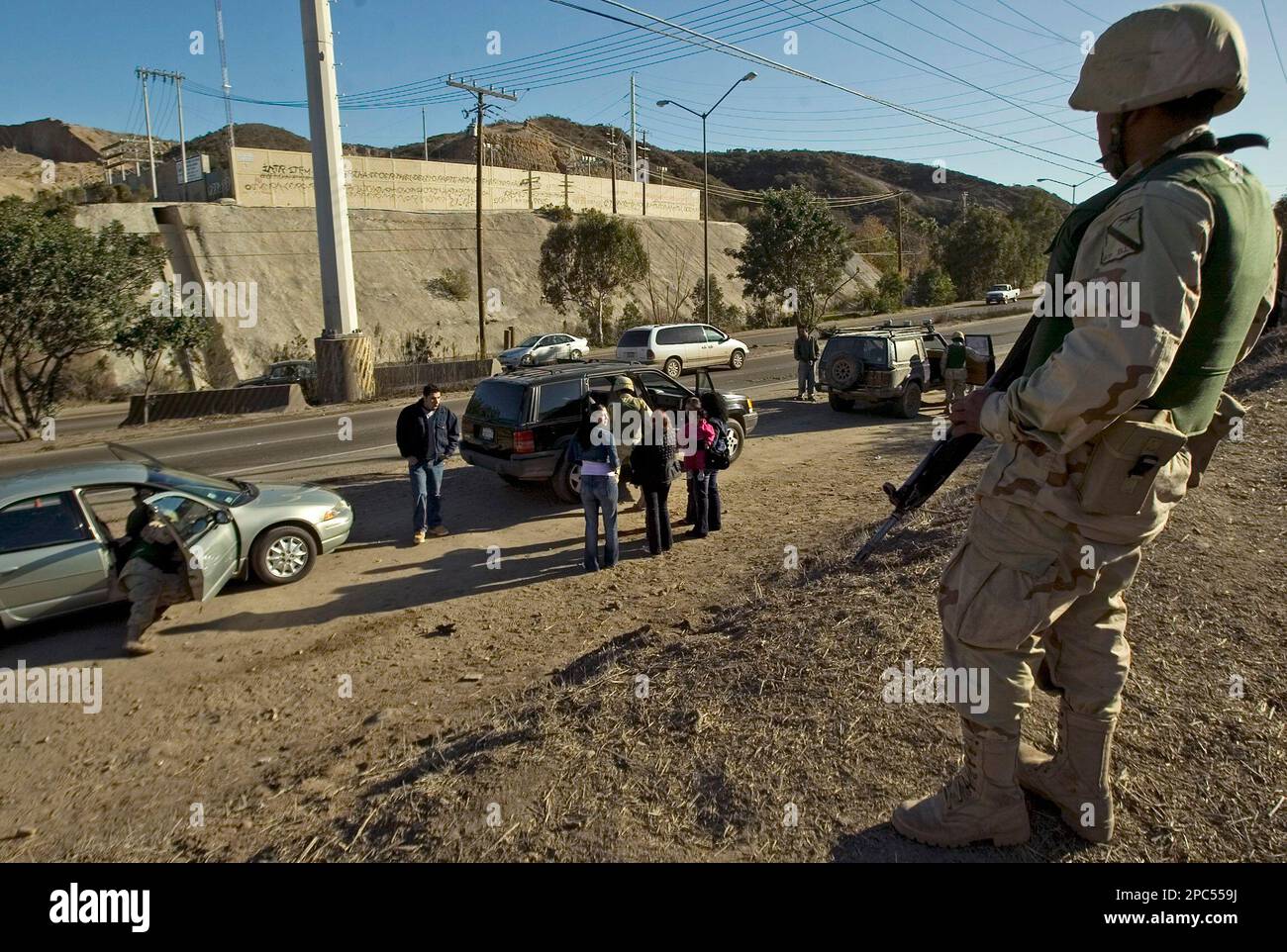 Mexican soldiers search vehicles in a checkpoint on the outskirts of ...
