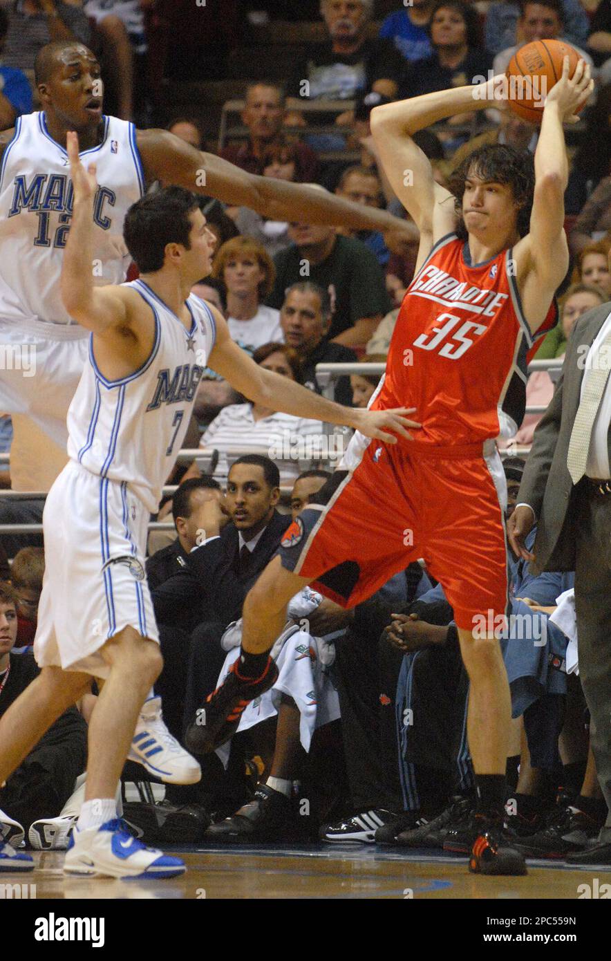 Charlotte Bobcats' Adam Morrison, right, looks to pass as Orlando Magic ...
