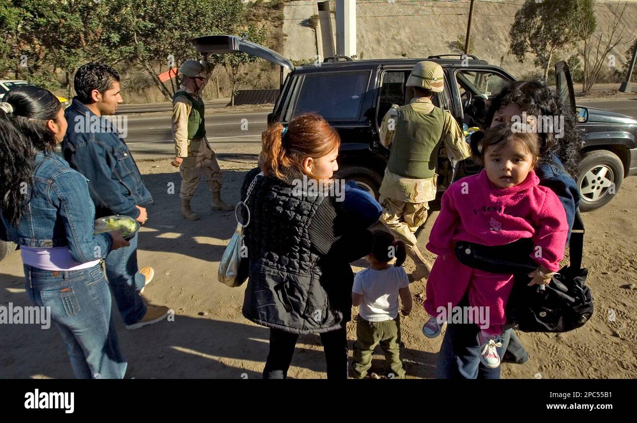 People watch as Mexican soldiers search a vehicle in a checkpoint on ...