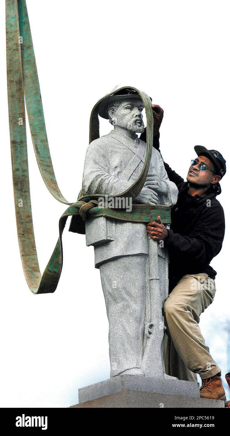 Kerry Hawkins with Norfolk Monument Company removes the lifting straps ...