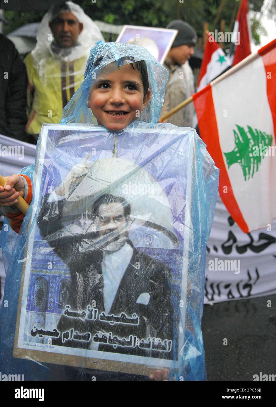 A Lebanese child holds a picture of Iraq's executed former President ...
