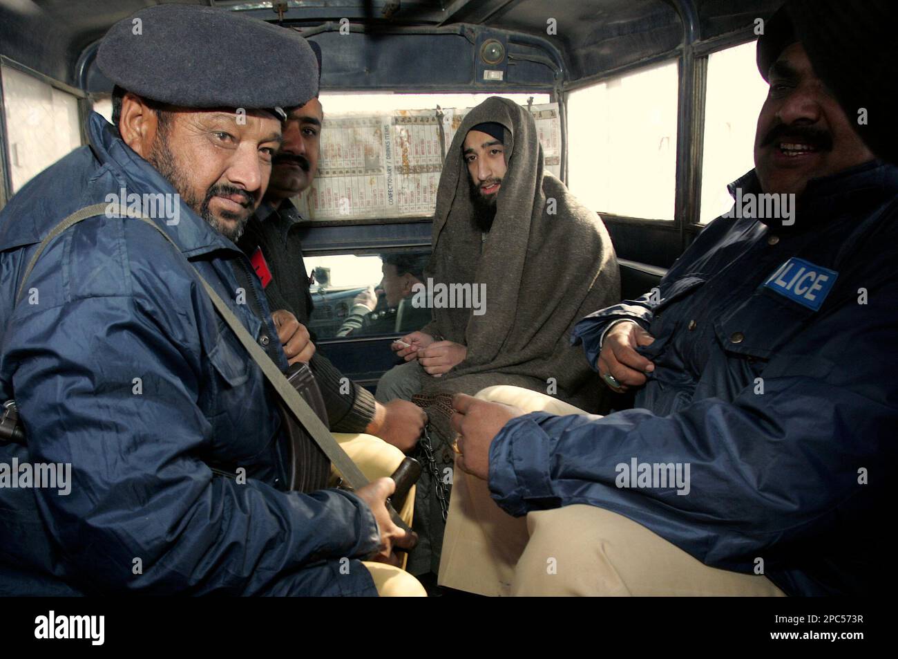 Pakistani police officers escort Rashid Rauf, second from right, a ...
