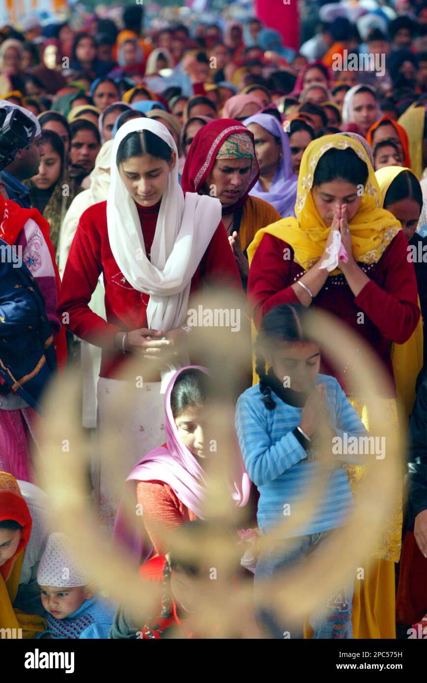 Devotees pray in front of a traditional Sikh icon at a Sikh temple in ...