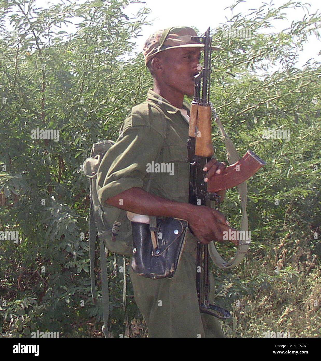 An armed Somali soldier stands guard where the Transitional Federal ...