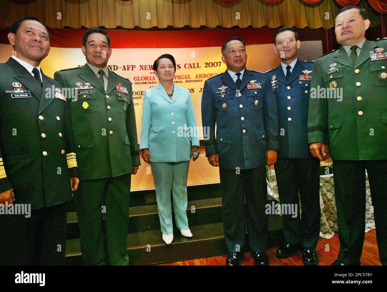 Philippine President Gloria Macapagal Arroyo, center, poses with her ...