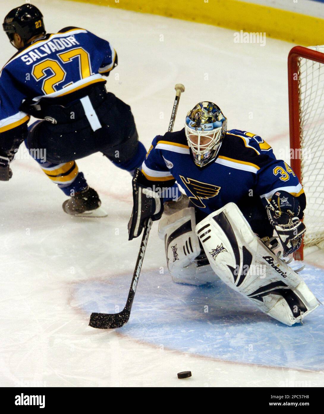 St. Louis Blues' Manny Legace, right, makes a first period save in ...