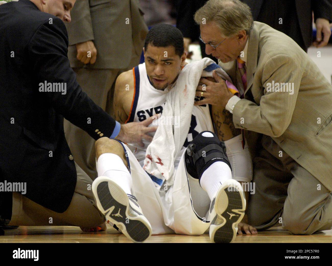 Syracuse's Terrence Roberts is helped to his feet after taking an elbow ...