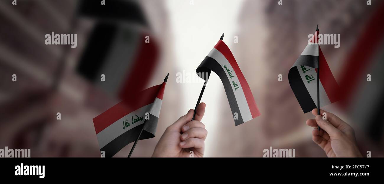 A group of people holding small flags of the Iraq in their hands Stock ...