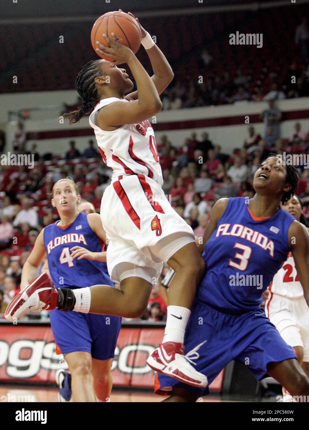 Georgia's Janese Hardrick, center, lays up a shot between Florida ...