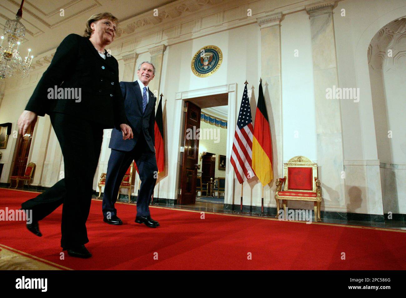 President Bush, right, and German Chancellor Angela Merkel walk away ...