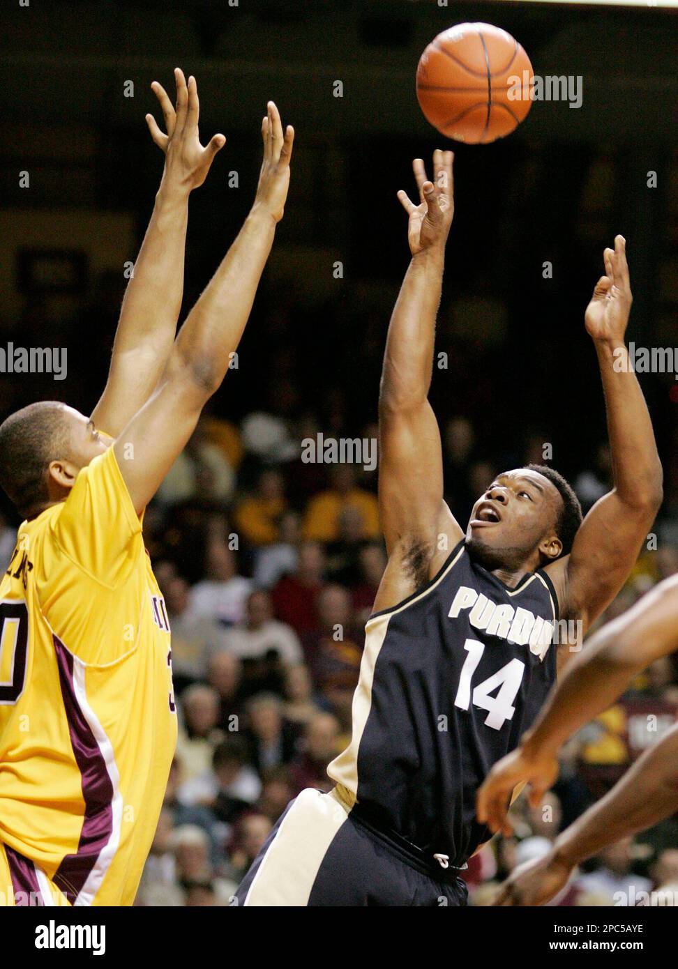 Purdue forward Carl Landry, right, shoots over Minnesota forward ...