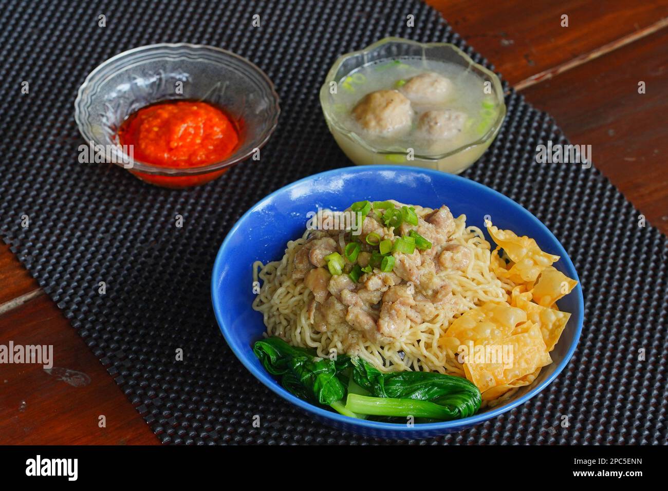 Mie Ayam or Indonesian chicken noodles with broth served in bowl with ...