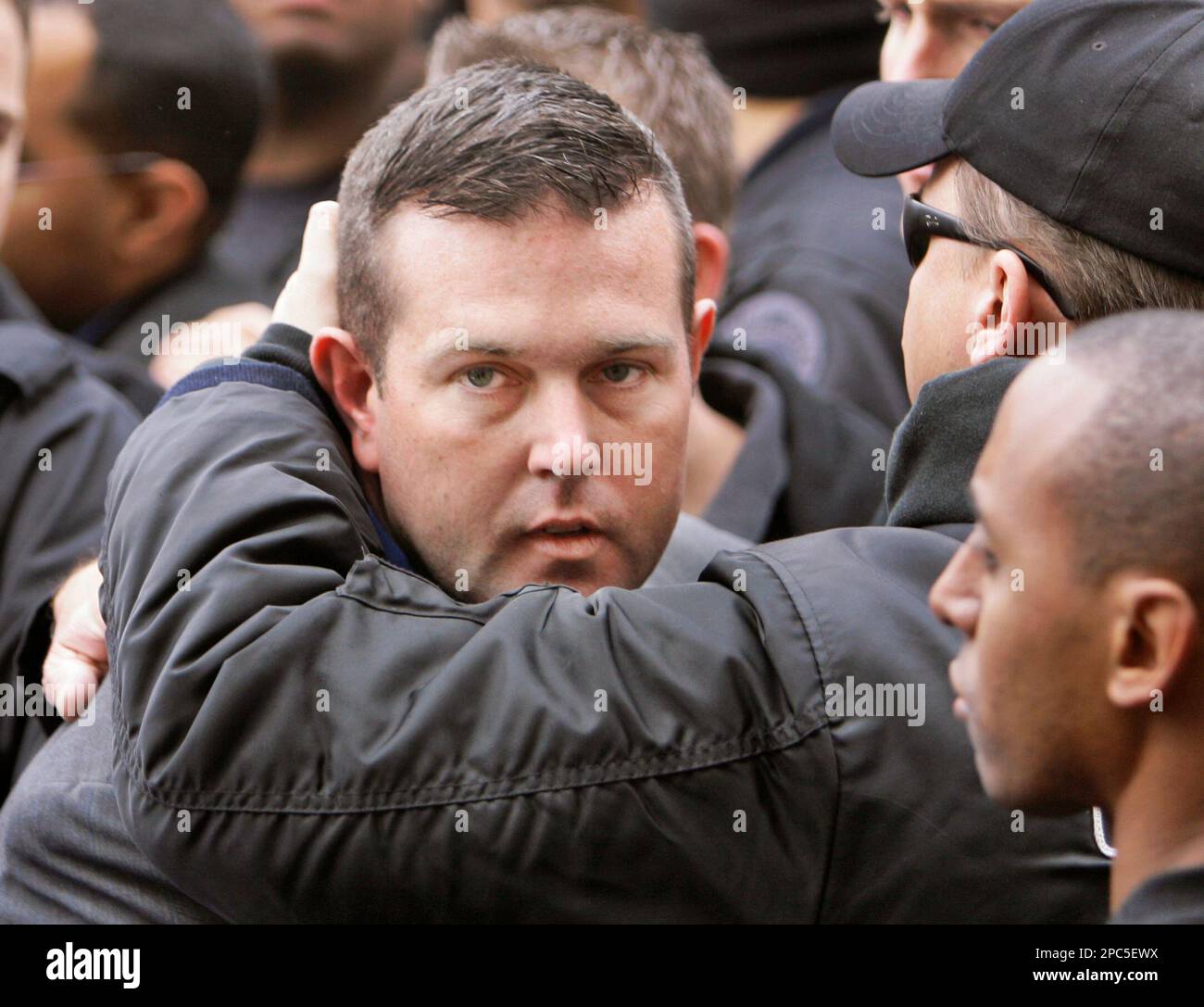 Sgt. Robert Gisevius Jr., left, hugs a fellow officer as he and six ...