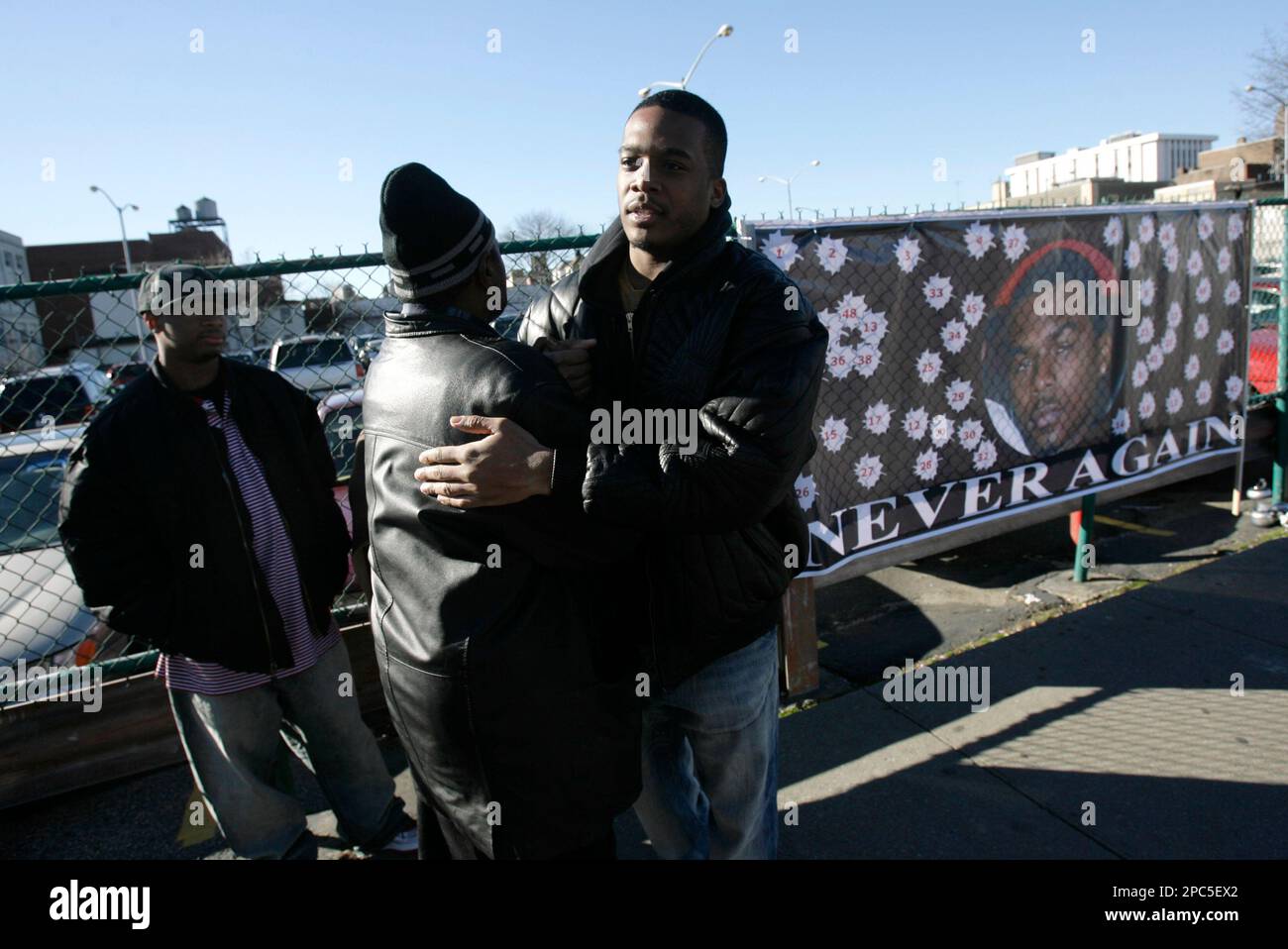 William Bell, Jr., right, brother of Sean Bell, hugs William Smith as ...