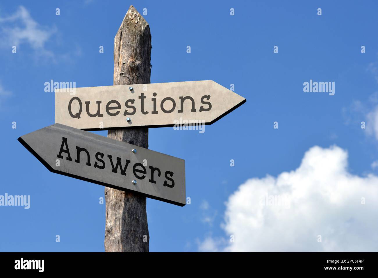 Questions and answers - wooden signpost with two arrows, sky with ...