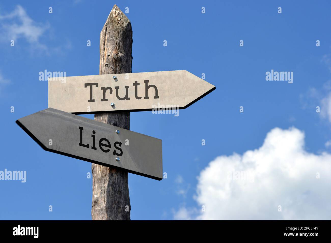 Truth and lies - wooden signpost with two arrows, sky with clouds Stock ...