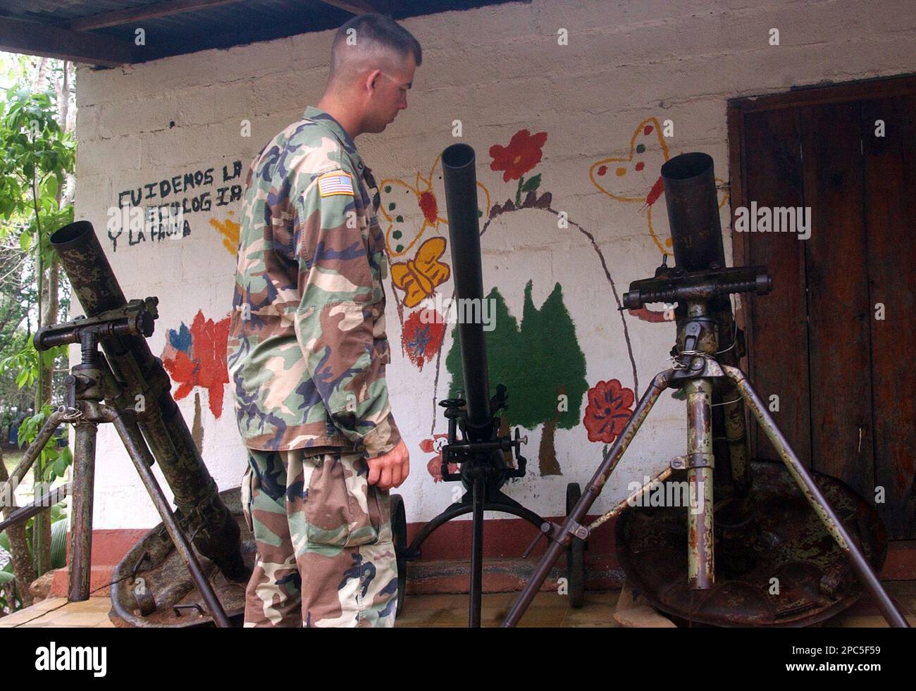 An unidentified U.S. Army soldier looks at mortars on display at the ...