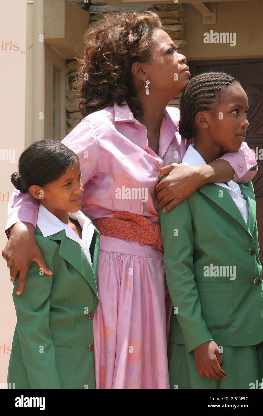 U.S. talk show queen Oprah Winfrey, center, with two learners, during ...