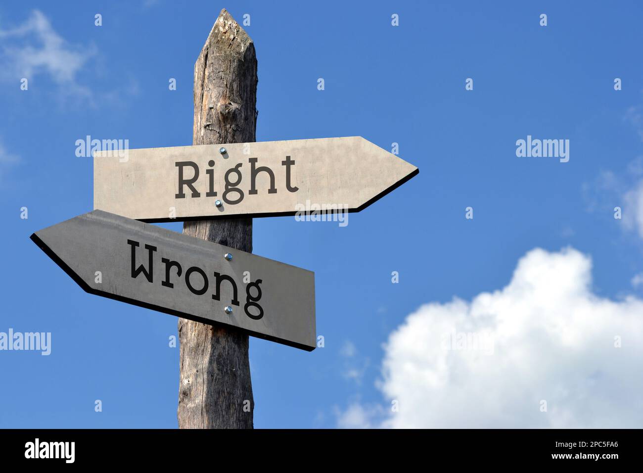 Right or wrong - wooden signpost with two arrows, sky with clouds Stock ...