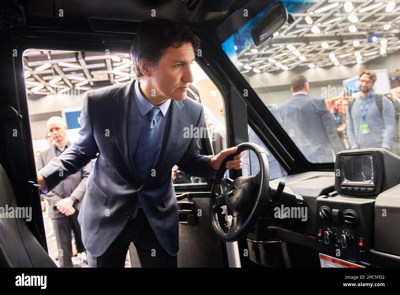 Prime Minister Justin Trudeau looks into the cabin of an electric ...