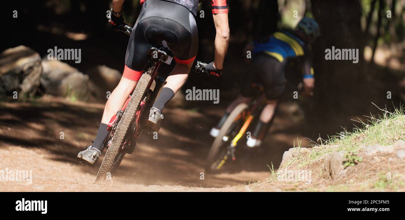 Mountain bikers riding on bike singletrack trail, mountain bike race ...