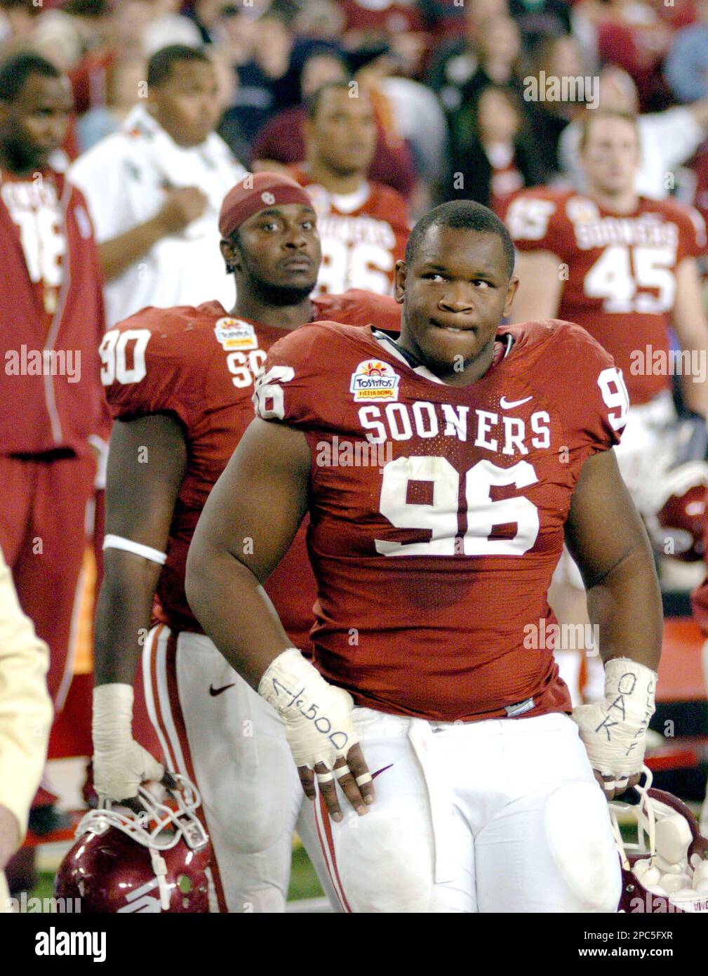 Oklahoma's DeMarcus Granger (96) and Steven Coleman (90) watch from the ...