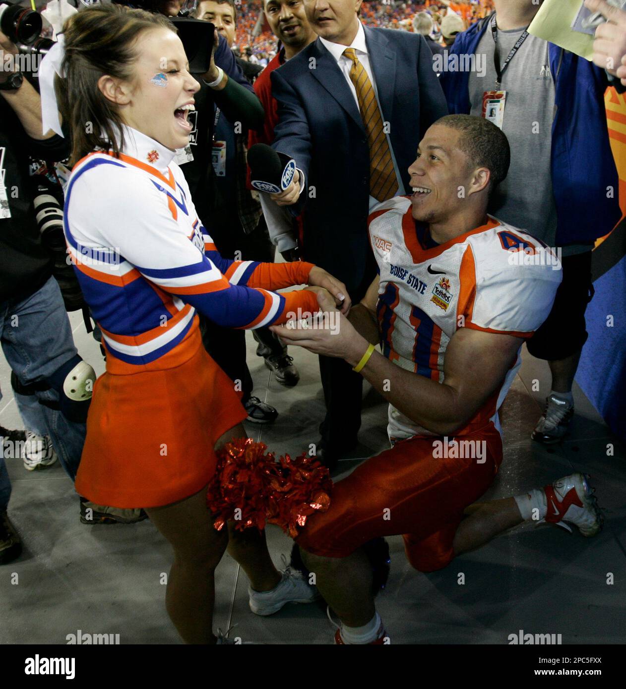 Boise State running back Ian Johnson, right, proposes to his girlfriend ...