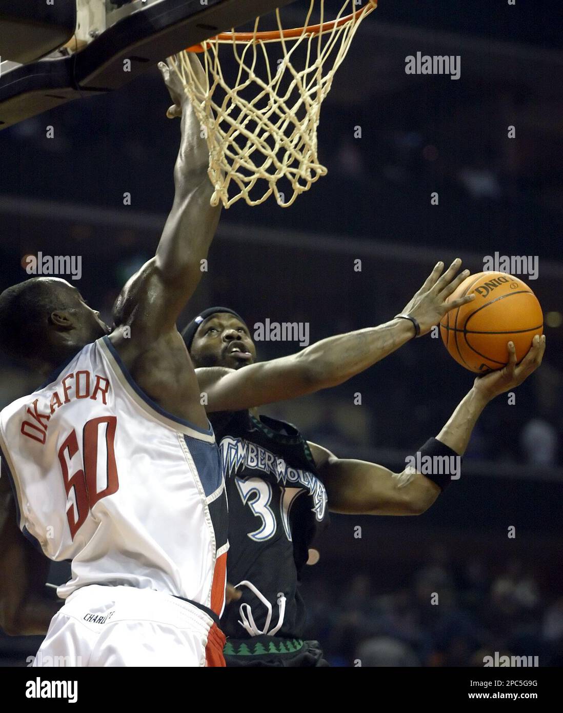 Minnesota Timberwolves guard Ricky Davis, right, drives to the basket ...