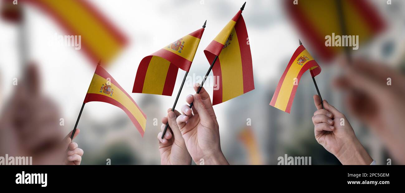 A group of people holding small flags of the Spain in their hands Stock ...