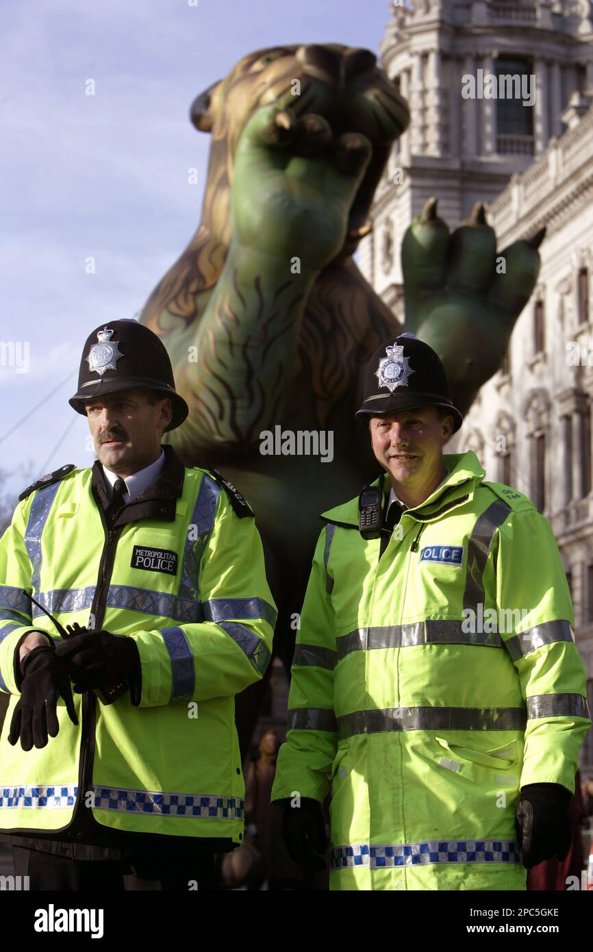 Backdropped by an inflatable monster, British police officers provide ...
