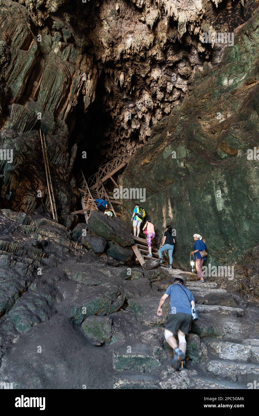 Local tour guide with traditional lantern guiding tourists through the ...