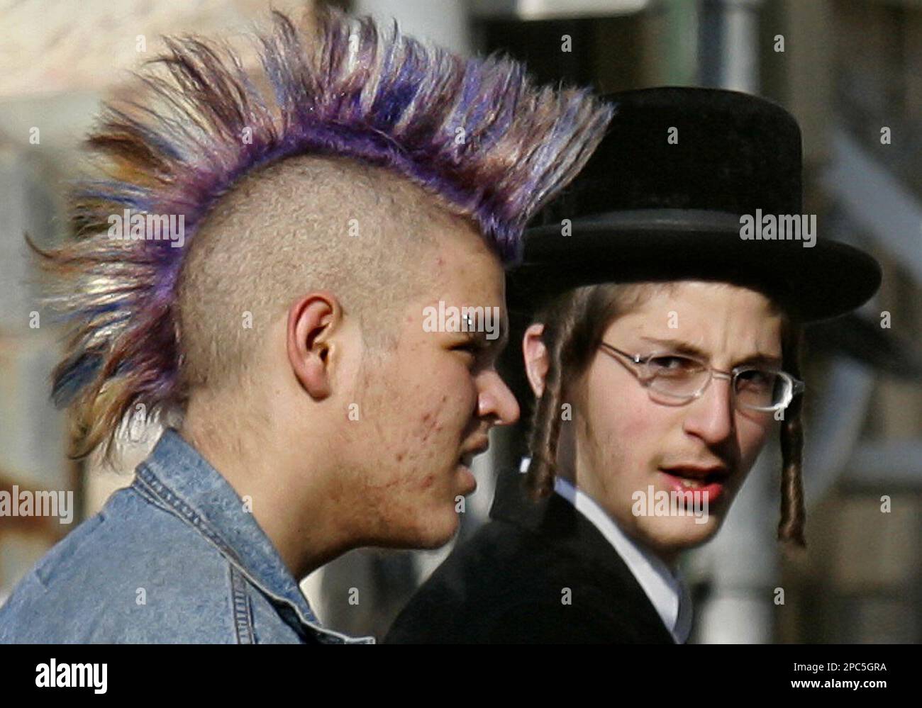 An Israeli wearing a punk-rock hairstyle chats with an Israeli ultra ...