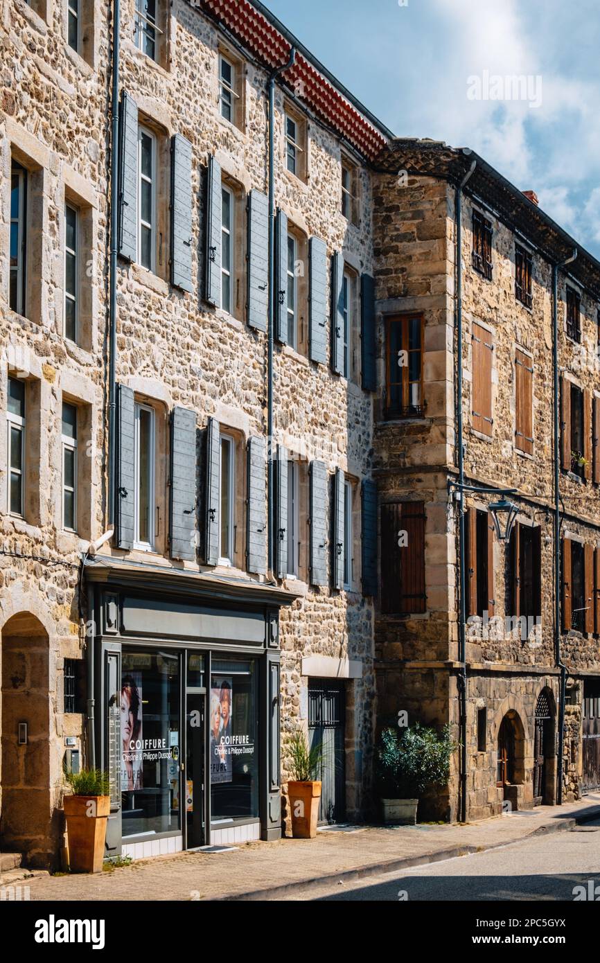 Quaint stone facades and haidresser wooden storefront in the medieval ...