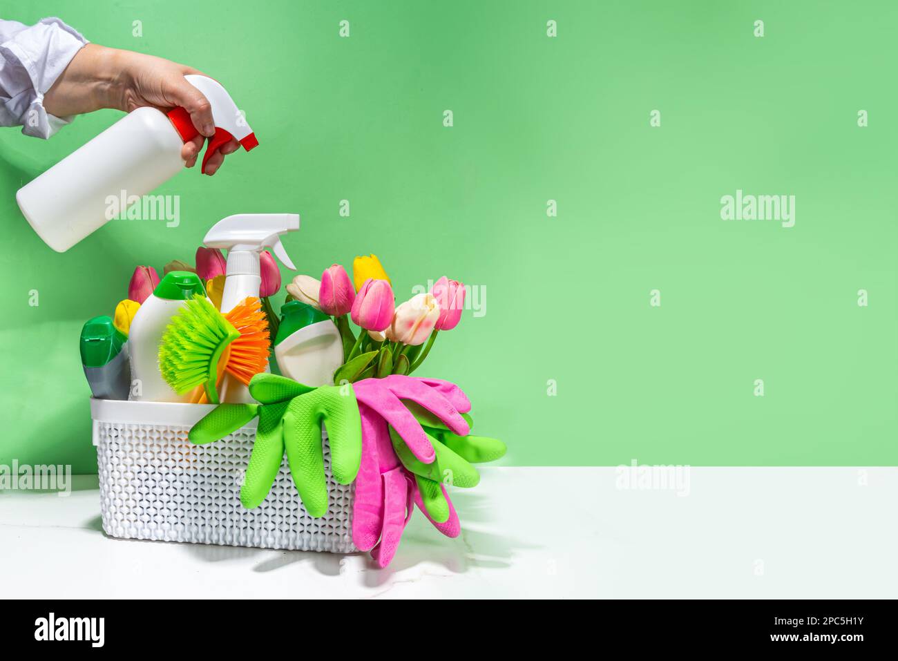 Set of cleaning supplies and utensils, with spring flowers on high ...